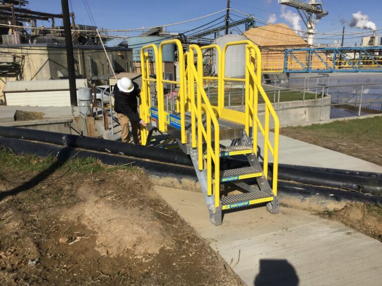 Erectastep industrial crossover stairs over outdoor pipe - ErectaStep